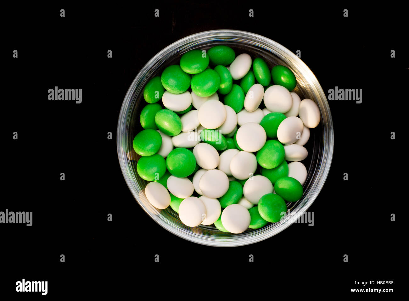 Green and white mints in glass bowl Stock Photo - Alamy