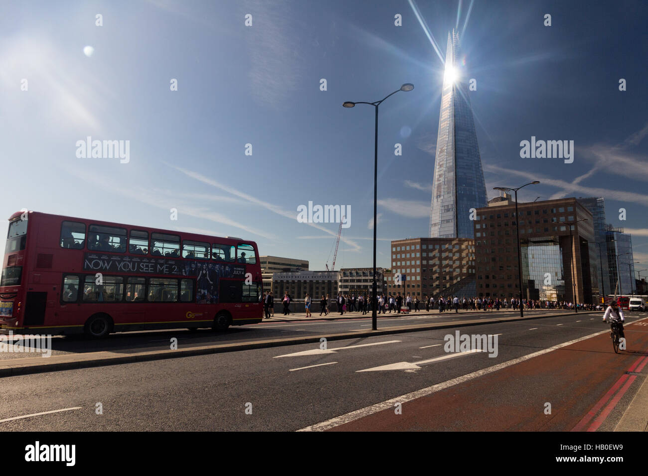 Cycling to work across London Bridge during the morning traffic, with ...