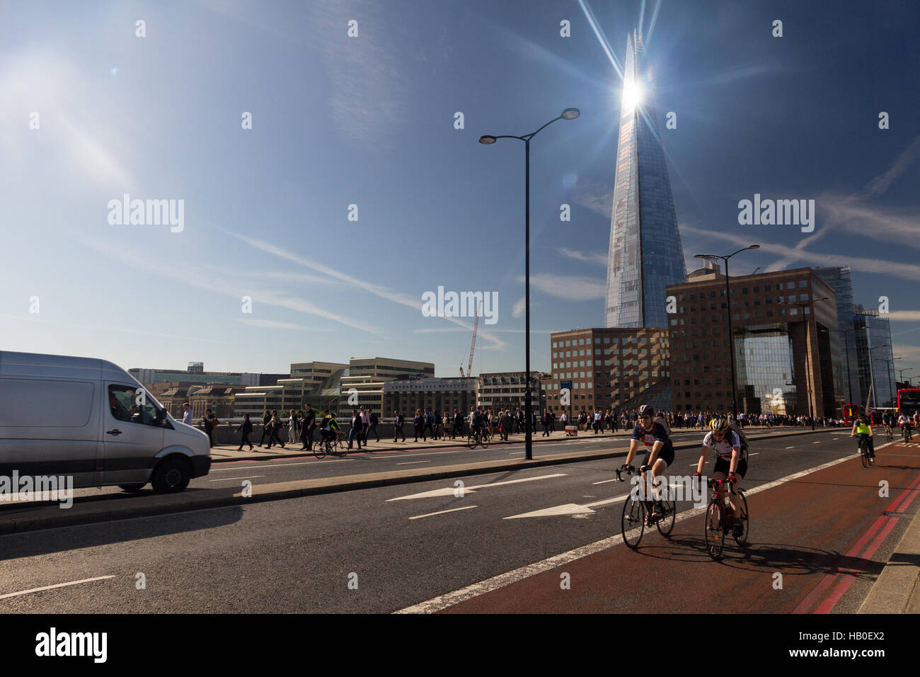 Cycling to work across London Bridge during the morning traffic, with ...