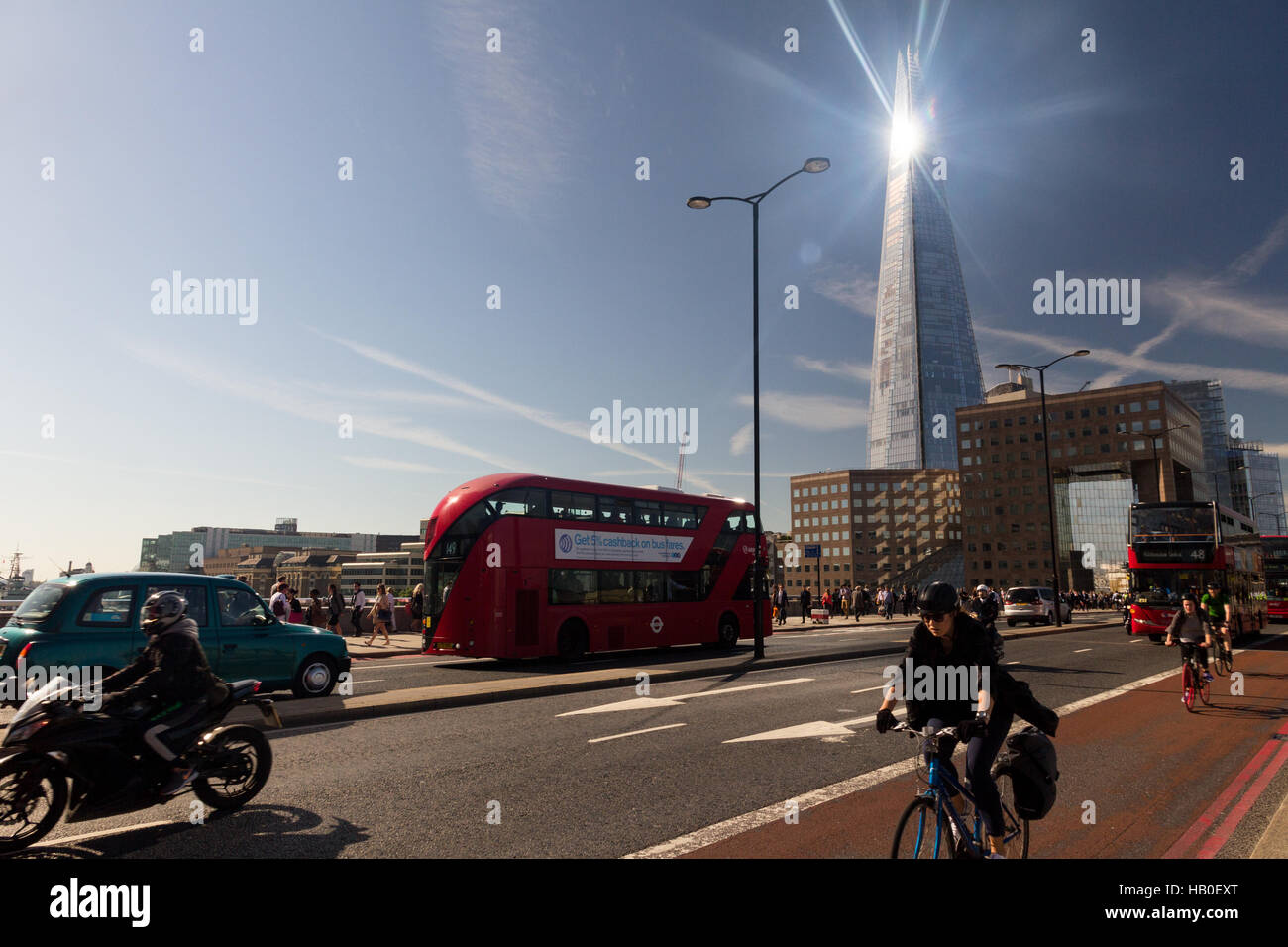 Cycling to work across London Bridge during the morning traffic, with ...