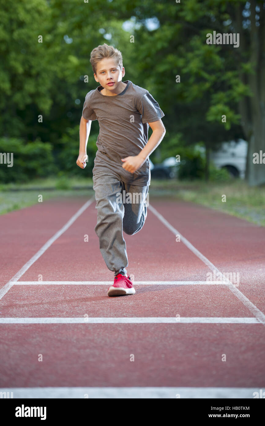 boy trained 100 m run 2 Stock Photo - Alamy