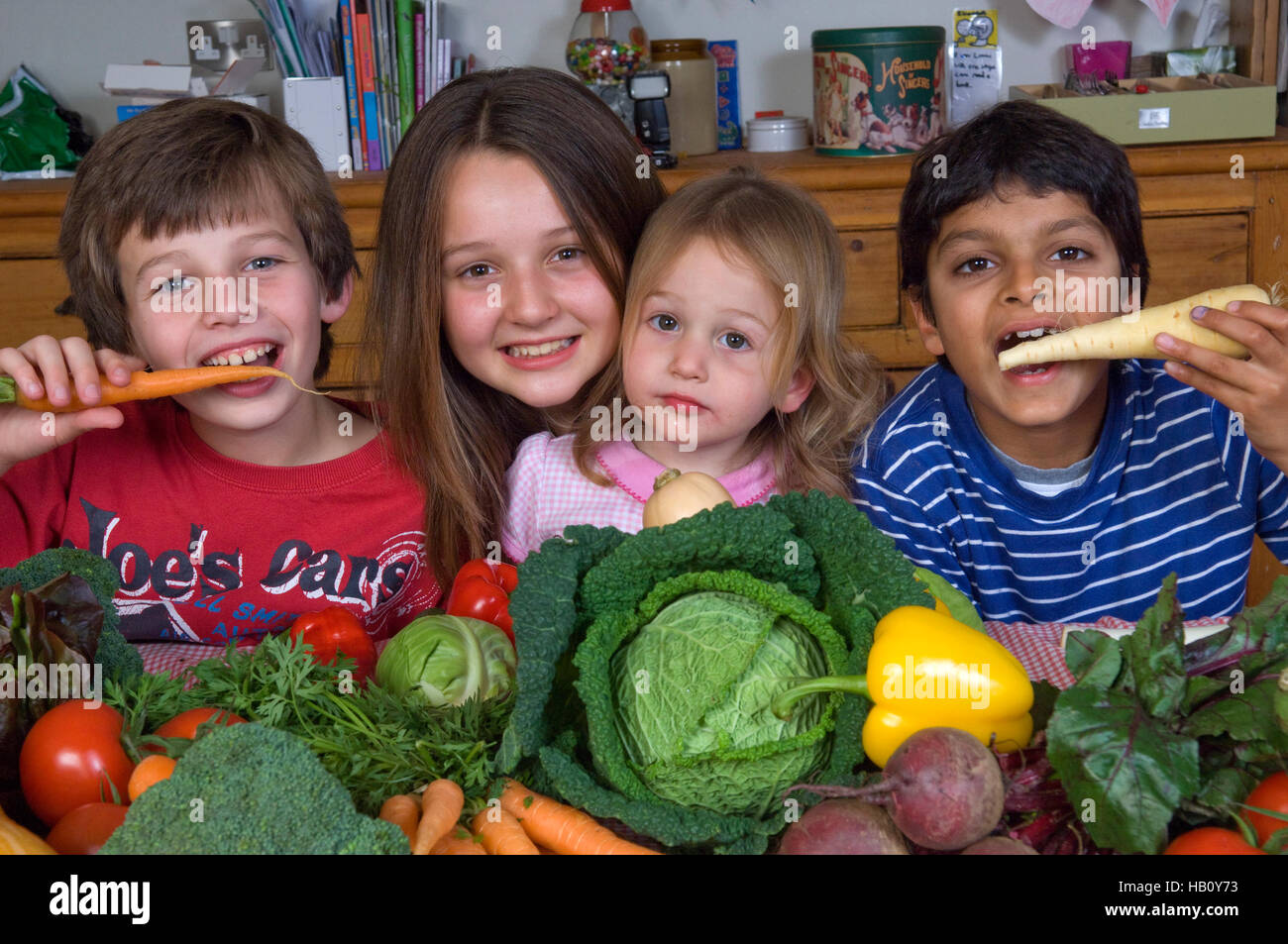 Children (2 boys and 2 girls) with a selection of healthy raw ...