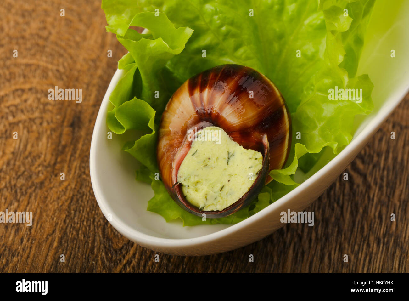 Escargot with cheese cream on salad leaves Stock Photo - Alamy