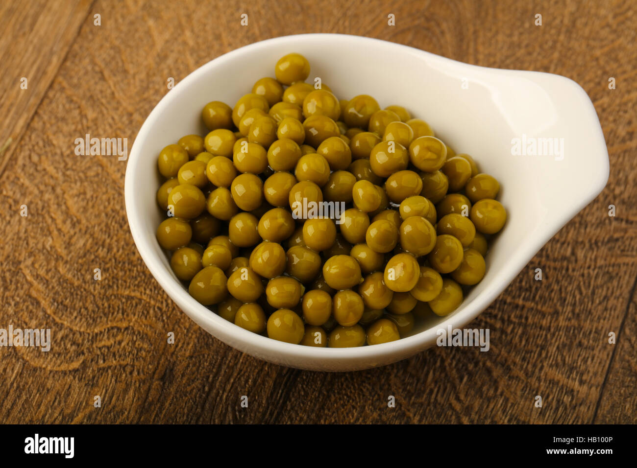 Pickled green pea on the wood background Stock Photo - Alamy