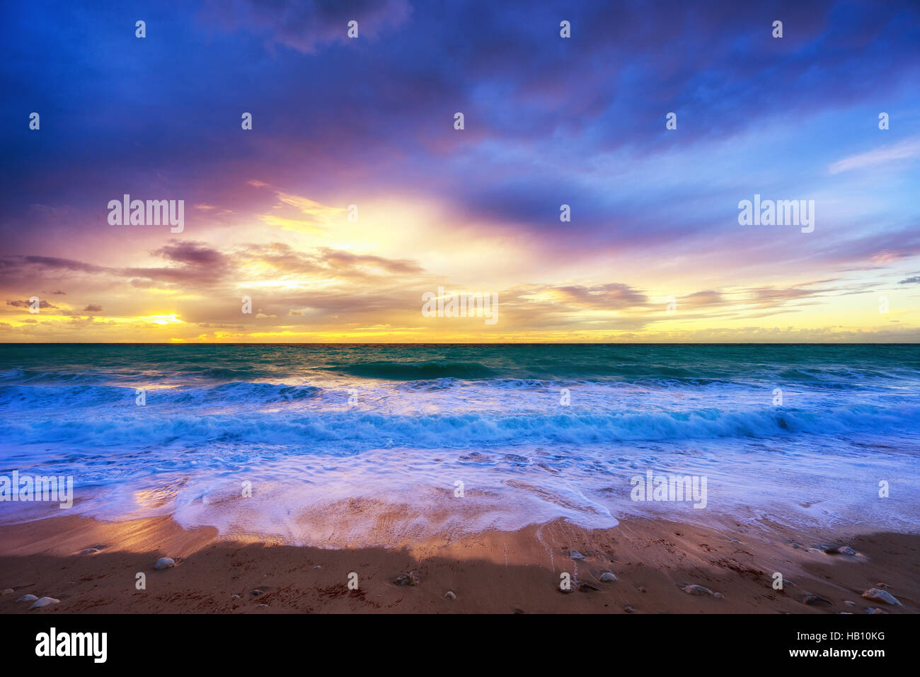 Sunset at the beach in Greece Stock Photo - Alamy