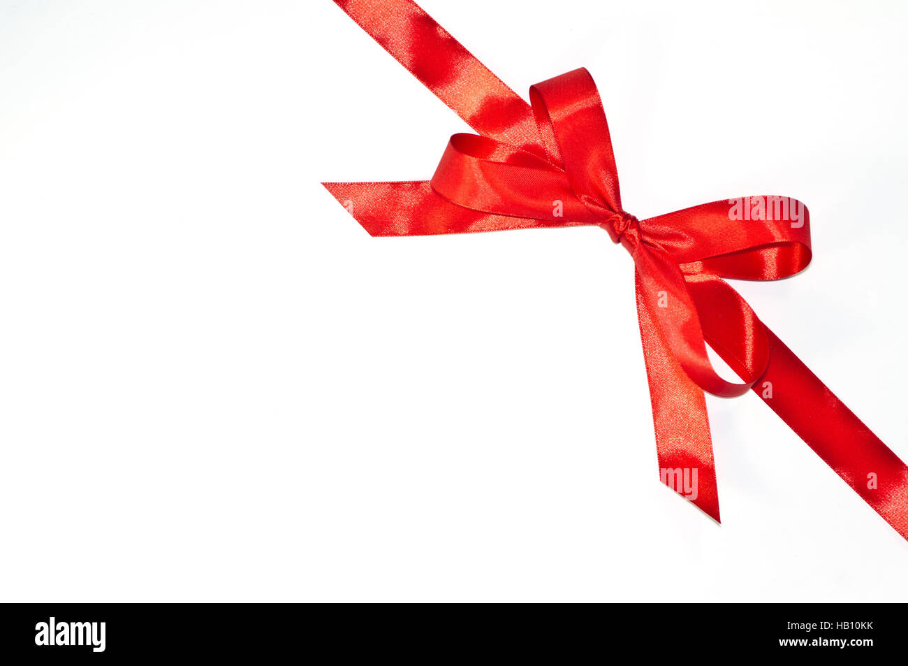 Red diagonal ribbon and bow isolated on white background Stock Photo ...
