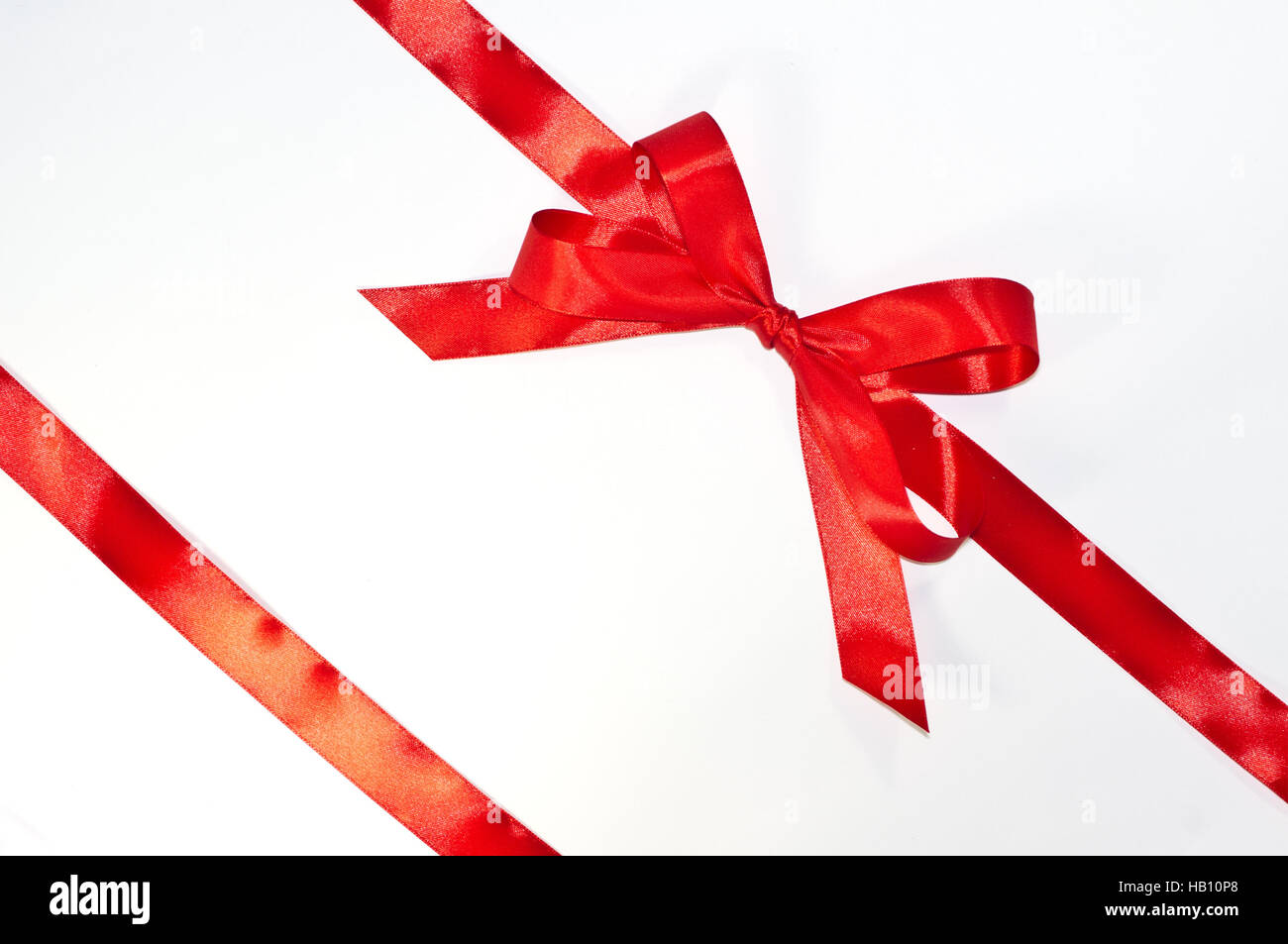 Red diagonal ribbons and bow isolated on white background Stock Photo ...