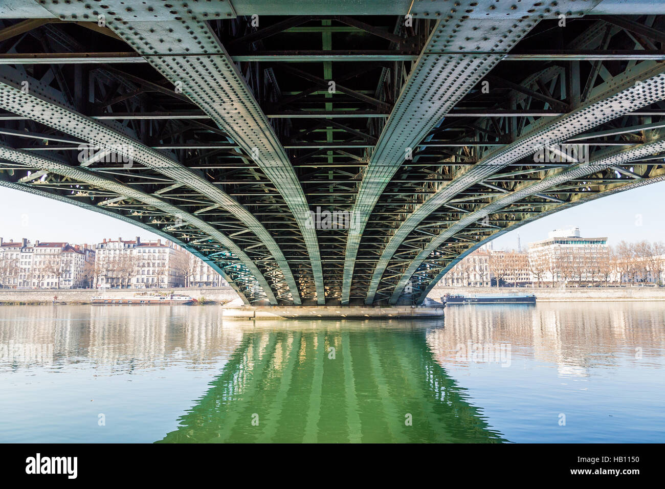 The metal arch of a bridge over a river Stock Photo - Alamy