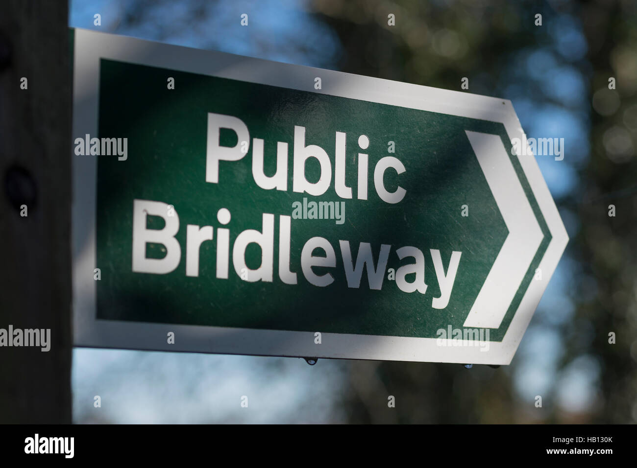 Public bridleway sign dappled by sunlight. Metaphor for 'right of way ...