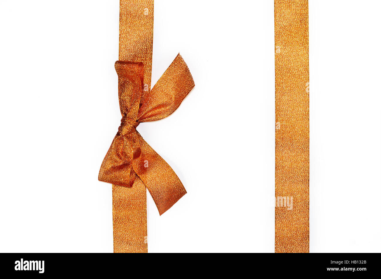 Golden vertical gift ribbons and luxurious bow isolated on white ...