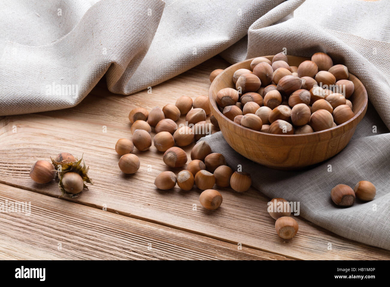 Hazelnuts on wooden table Stock Photo - Alamy