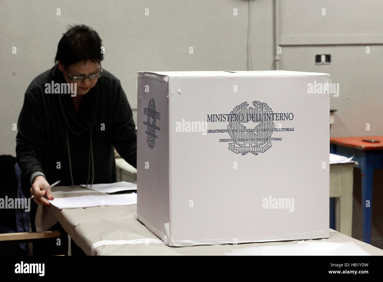 Rome, Italy. 03rd Dec, 2016. An official affixes labels to a voting ...