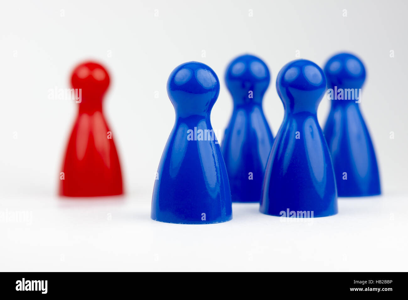 Conceptual game pawns Stock Photo - Alamy