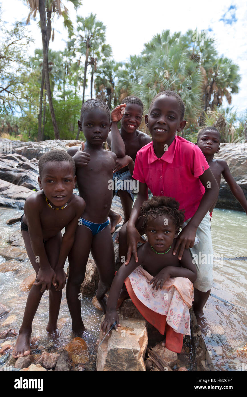 Himba children having fun in the river at the Epupa Falls river ...