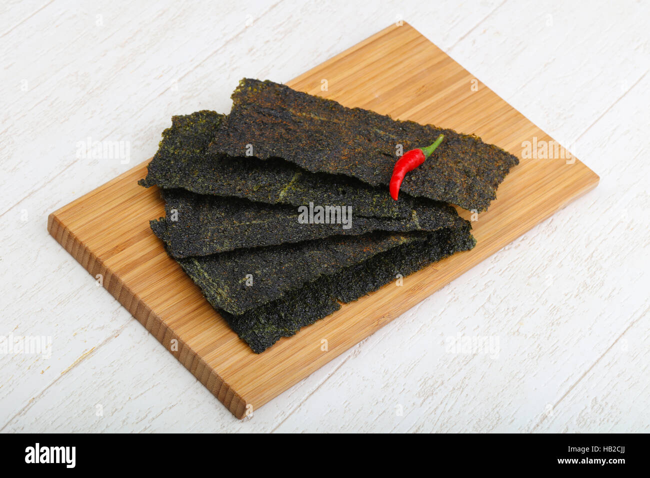 Spicy Nori seaweed sheets with pepper on wood Stock Photo - Alamy