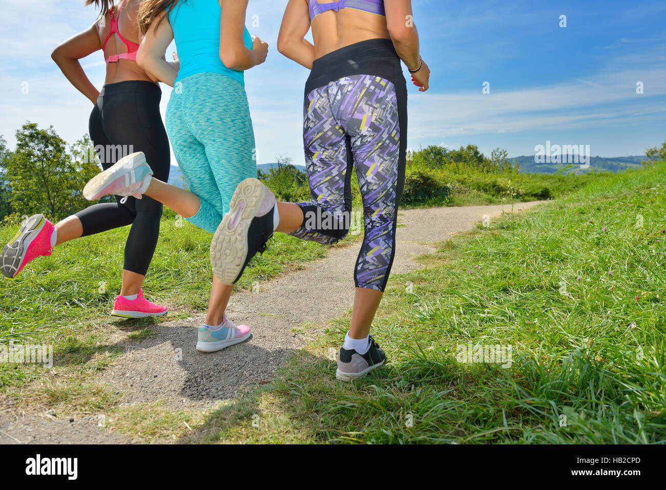 Three Female Joggers running together outdoors Stock Photo - Alamy