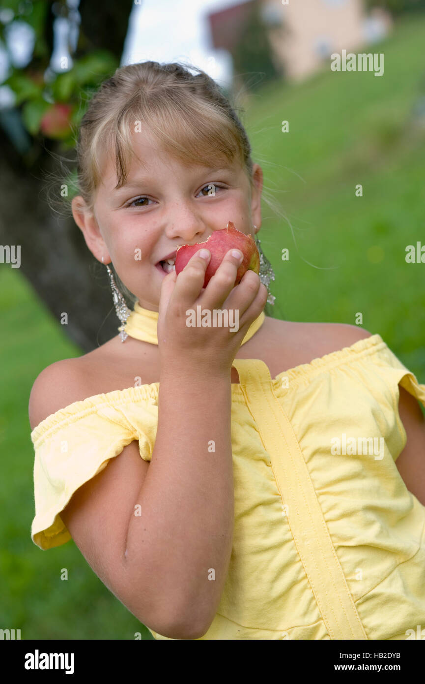 Girl eating an apple Stock Photo - Alamy