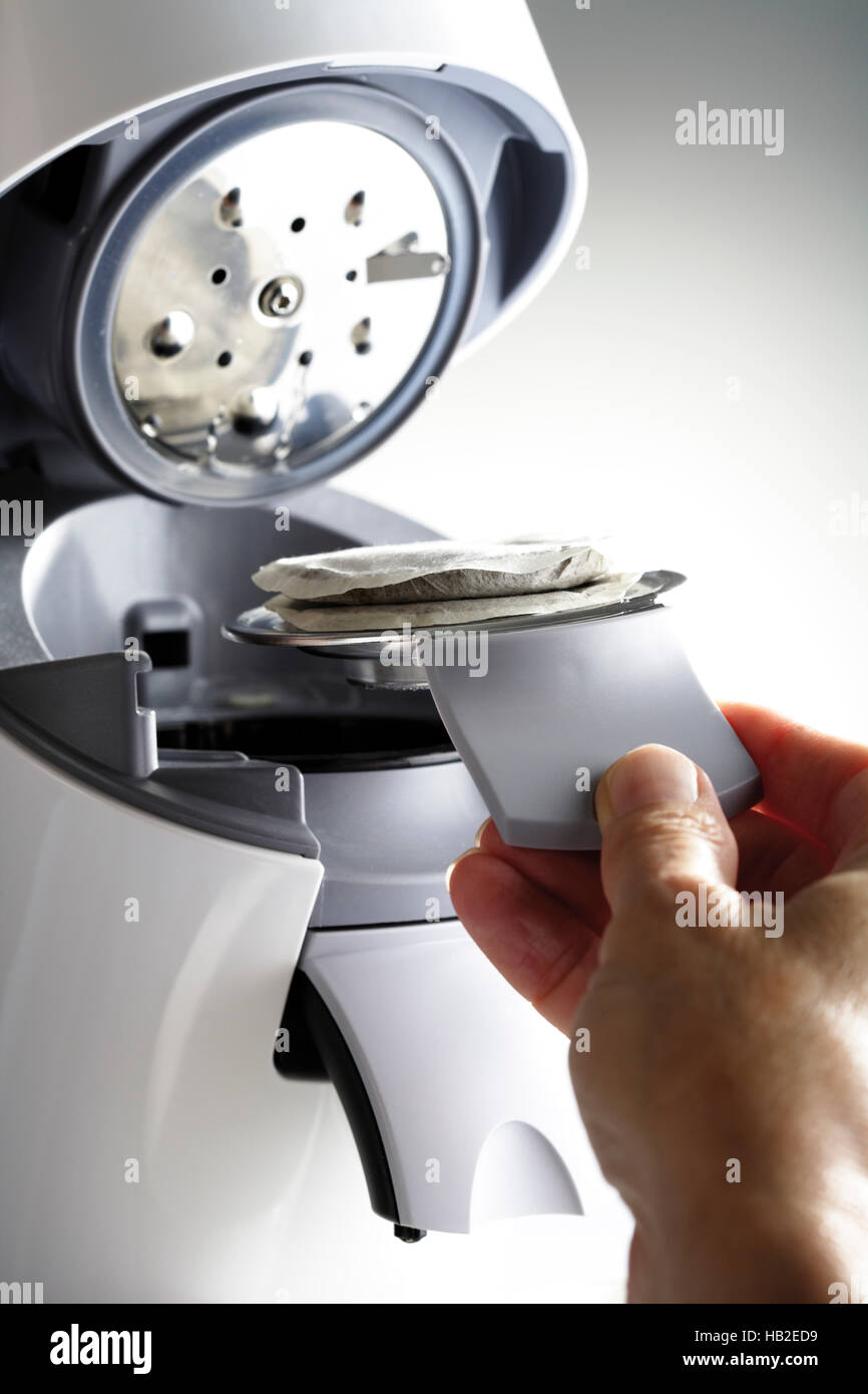 Hand operating coffee pad machine Stock Photo - Alamy