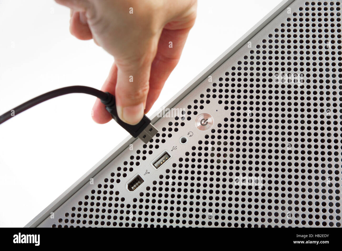 Hand plugging a USB cord into a computer Stock Photo - Alamy