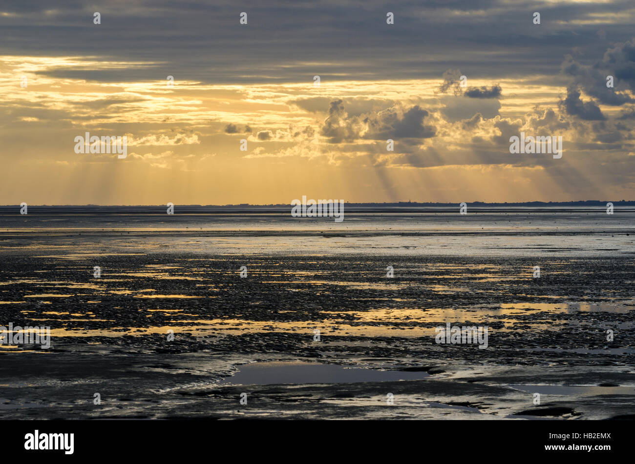 Clouds reflections in the still ocean from the beach, Bay of Saint ...