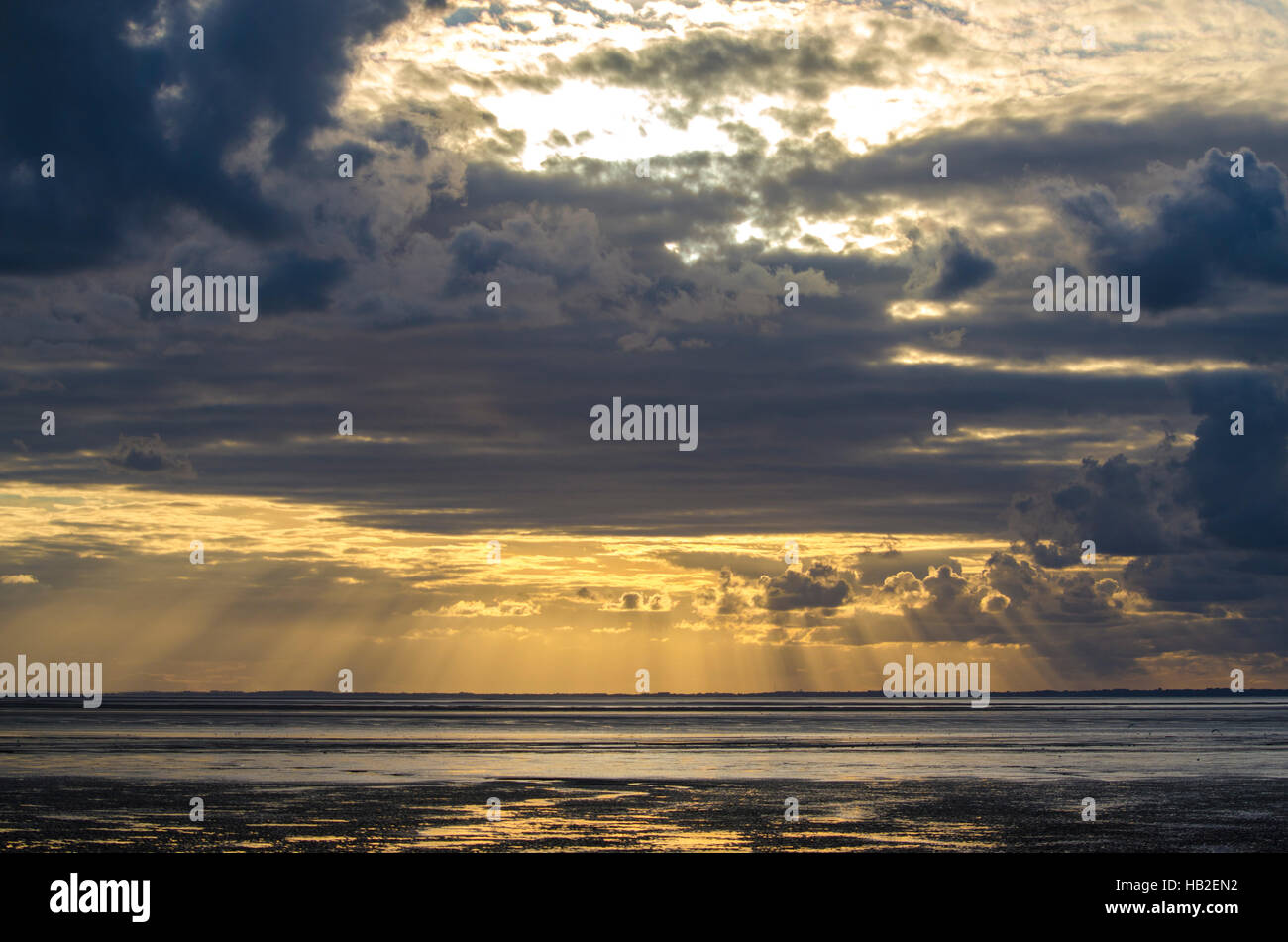 Clouds reflections in the still ocean from the beach, Bay of Saint ...