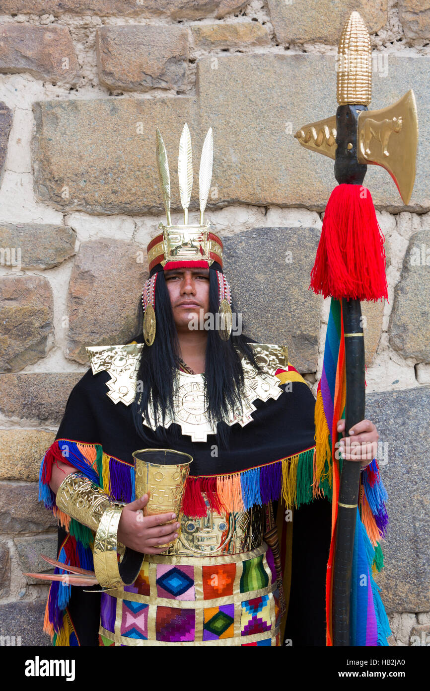 Peruvian man standing with traditional clothes, Inca ruins Stock Photo ...