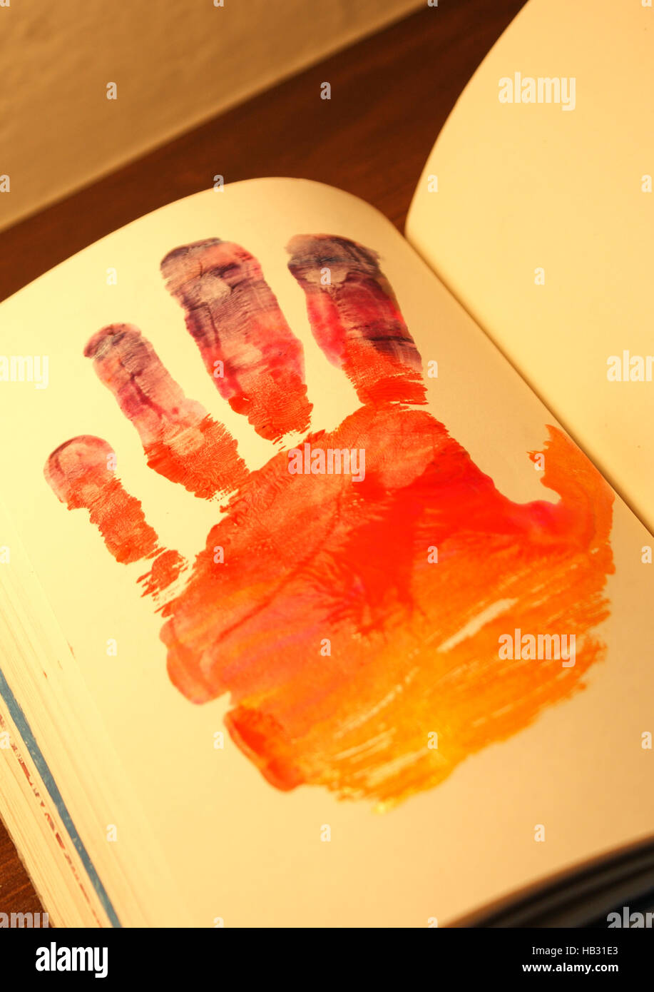Photograph of a human hand shape painted on a notebook Stock Photo - Alamy