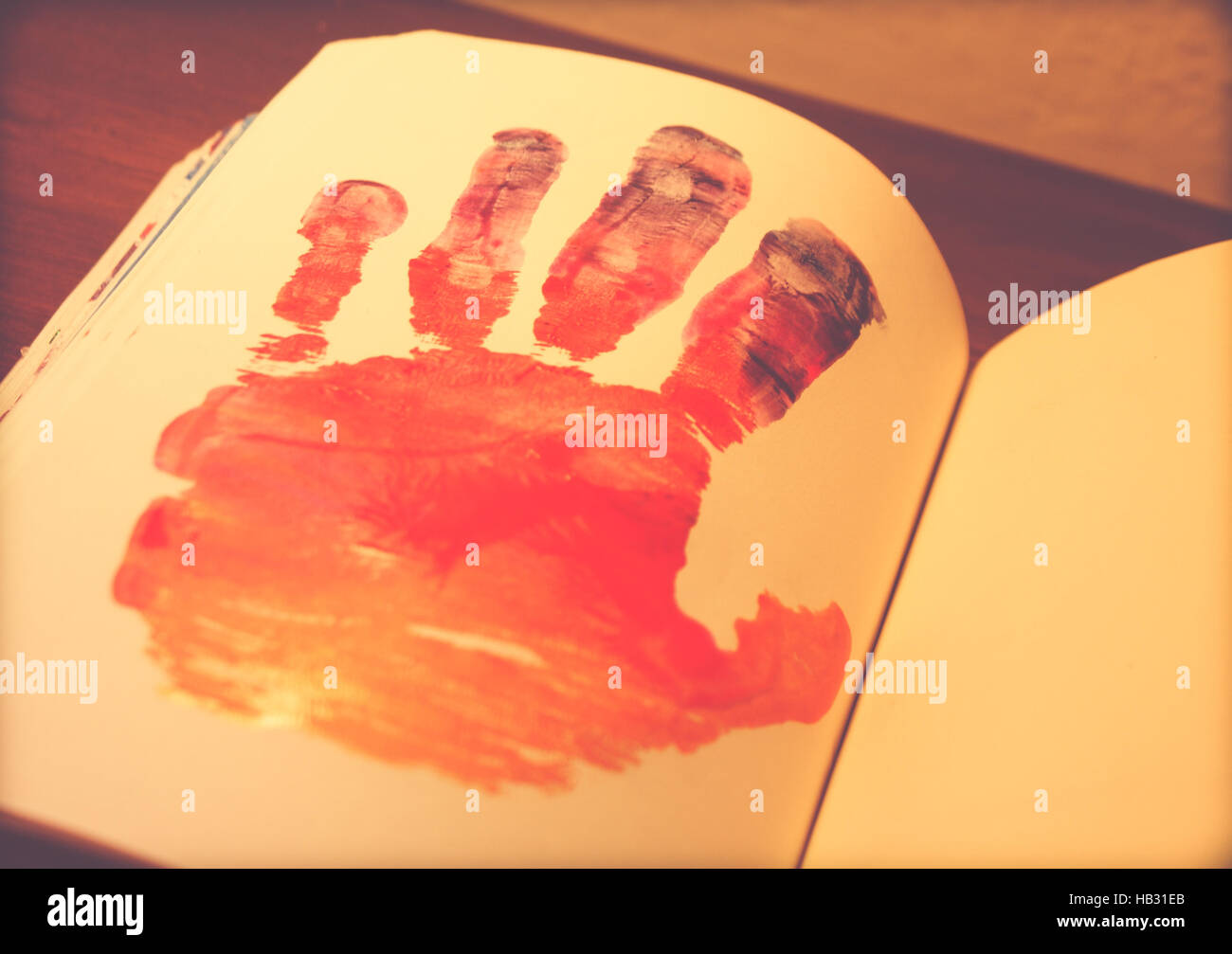 Photograph of a human hand shape painted on a notebook Stock Photo - Alamy