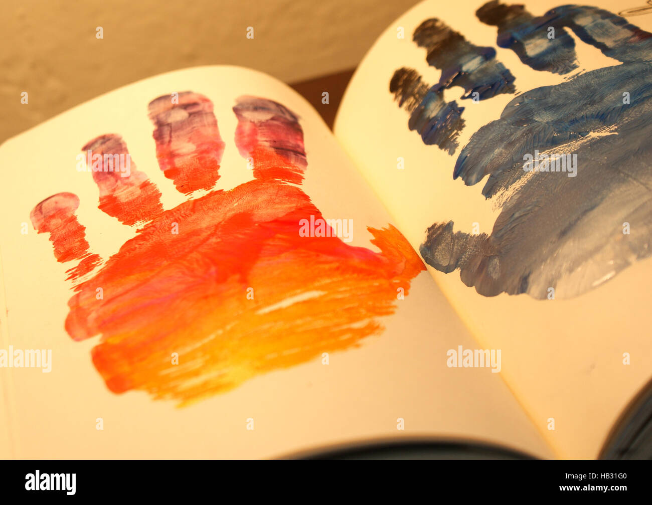 Photograph of a pair of human hands shapes painted on a notebook Stock ...