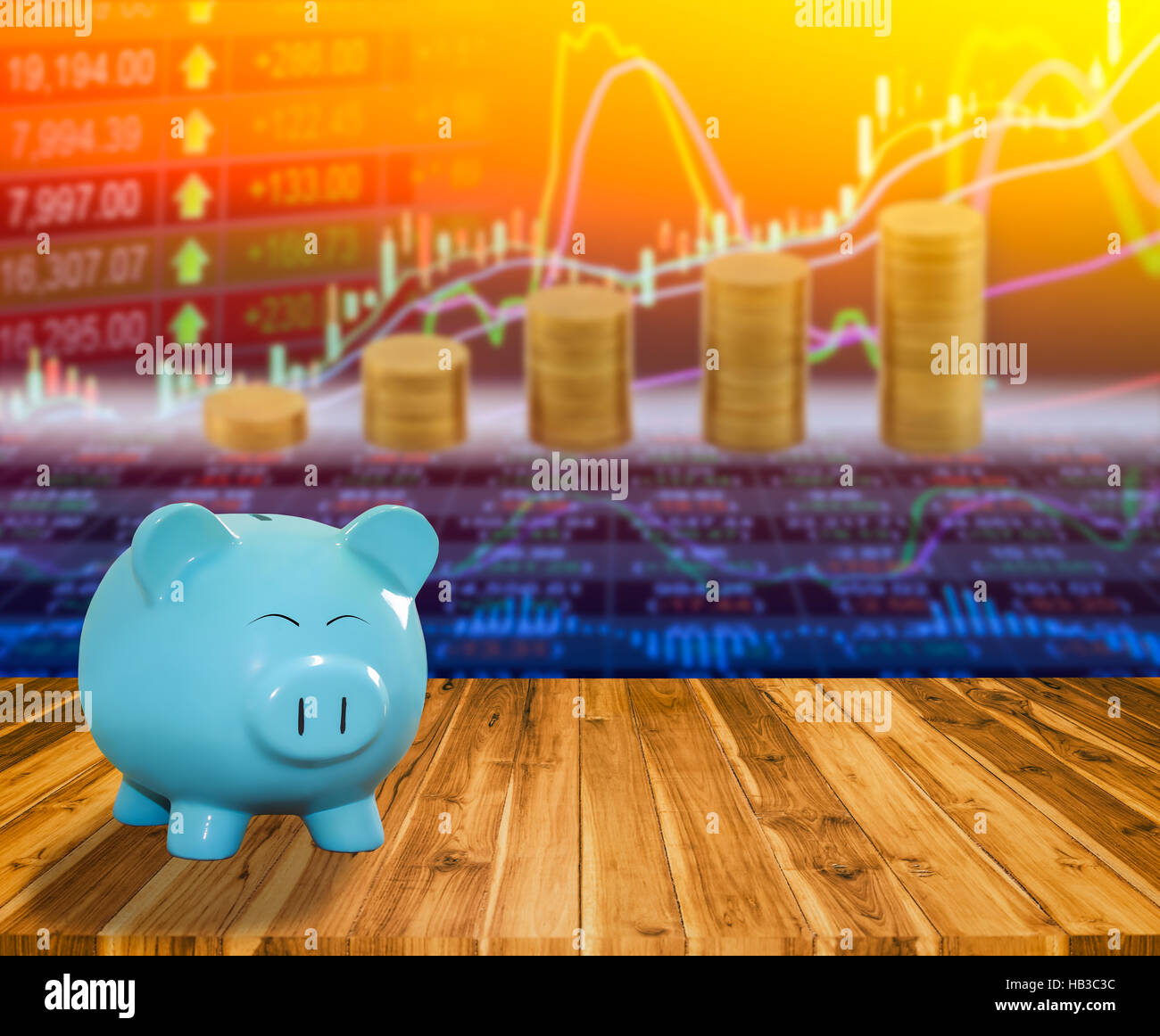 blue pig bank on wood background with blur stock market background ...