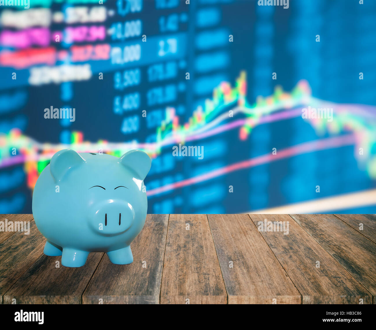 blue pig bank on wood background with blur stock market background ...