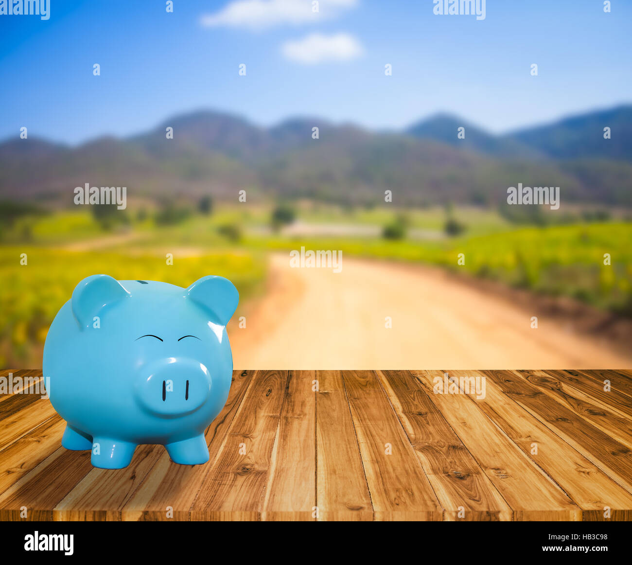 blue pig bank on wooden table with blur stock market background,money ...
