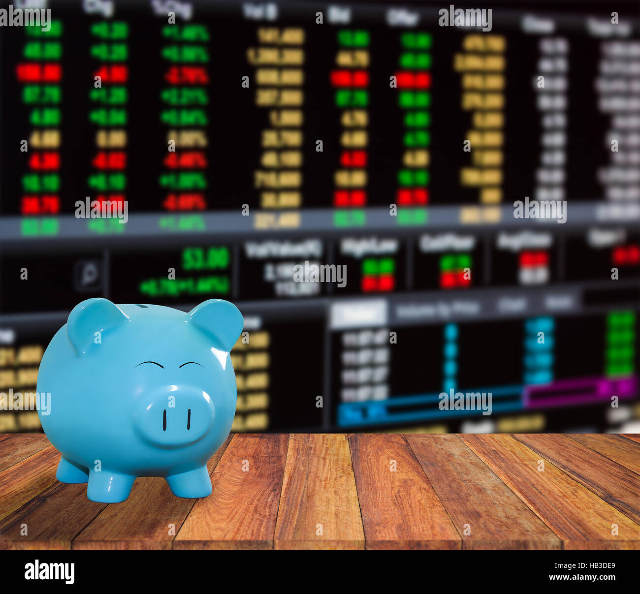 blue pig bank on wood background with blur stock market background ...