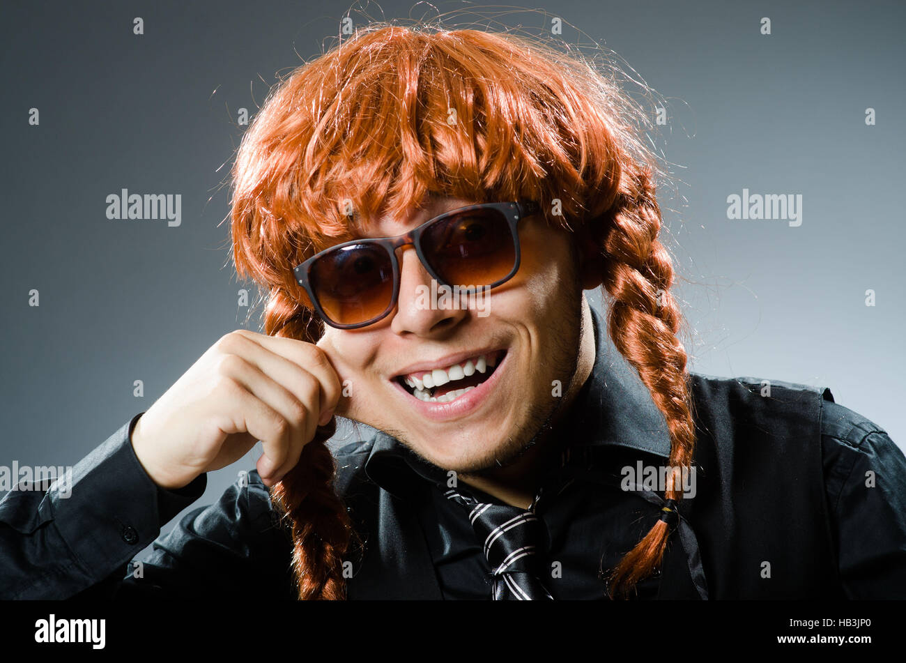 Funny man with red hair wig Stock Photo - Alamy