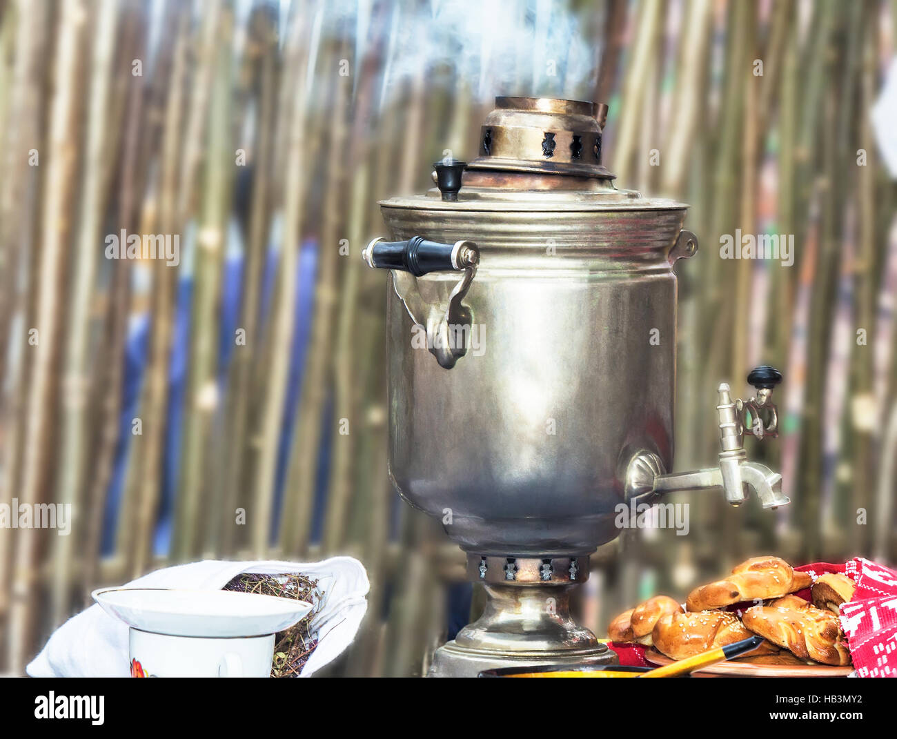 Boiling tea from the old samovar Stock Photo - Alamy