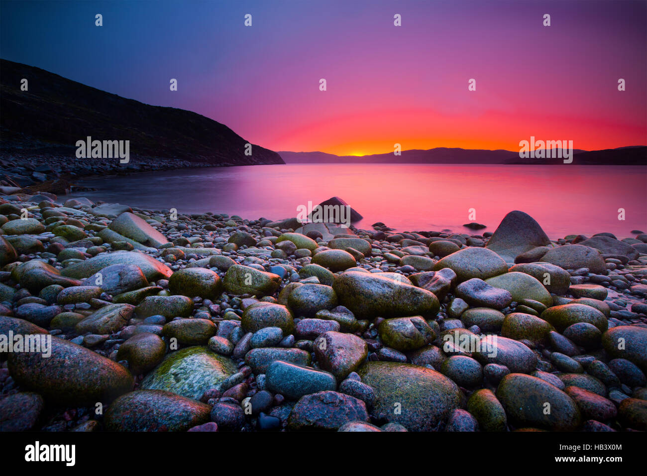 Sunset on the stone coast Stock Photo - Alamy