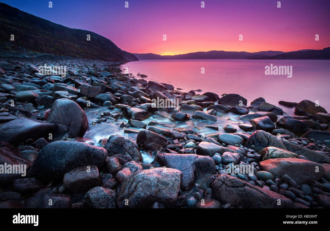 Sunset on the stone coast Stock Photo - Alamy