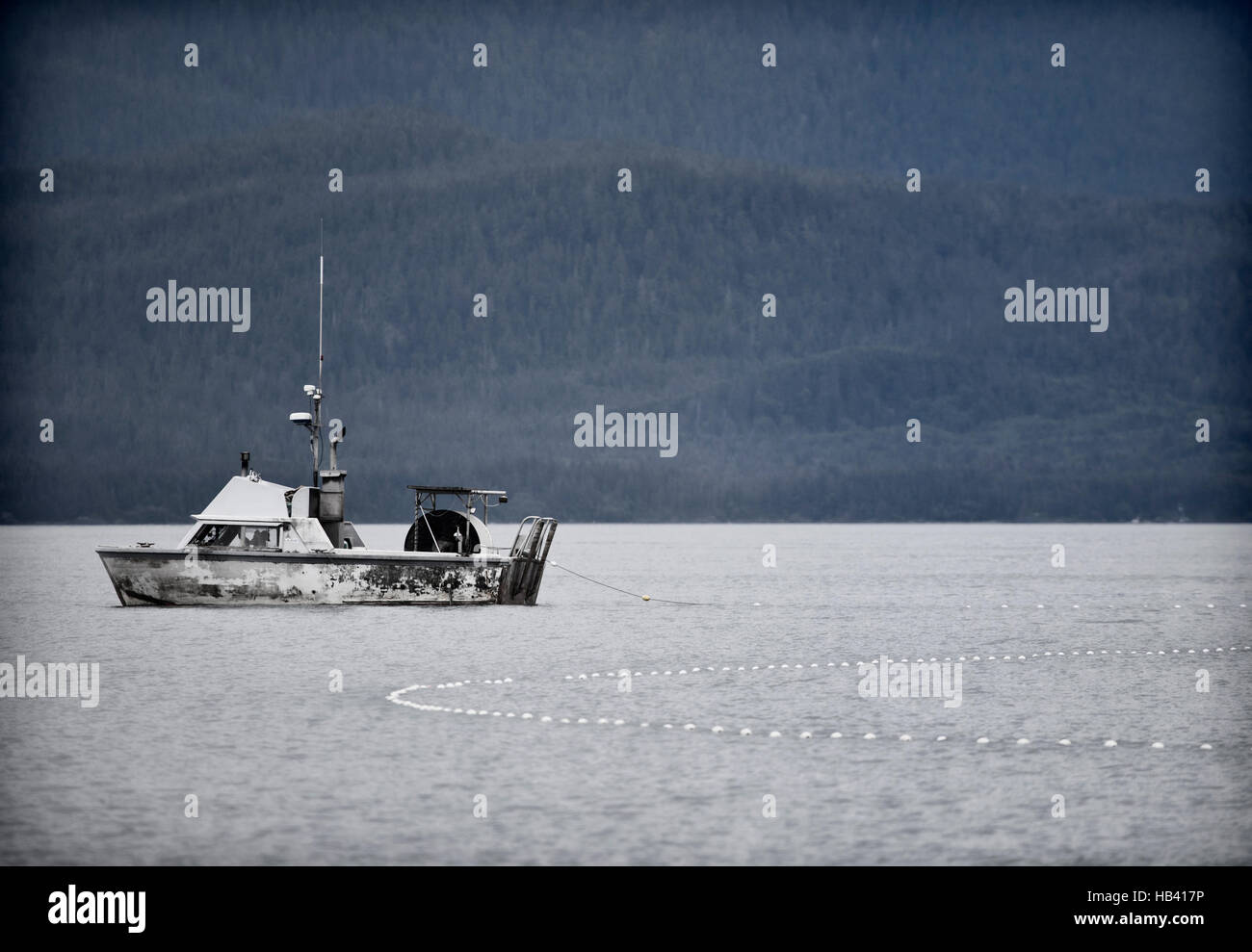 Old small commercial fishing boat with a set drift net salmon fishing ...