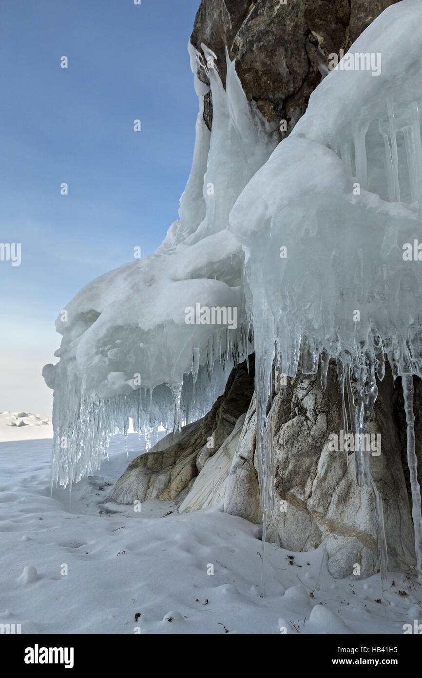 Huge icicles on rocks Stock Photo - Alamy