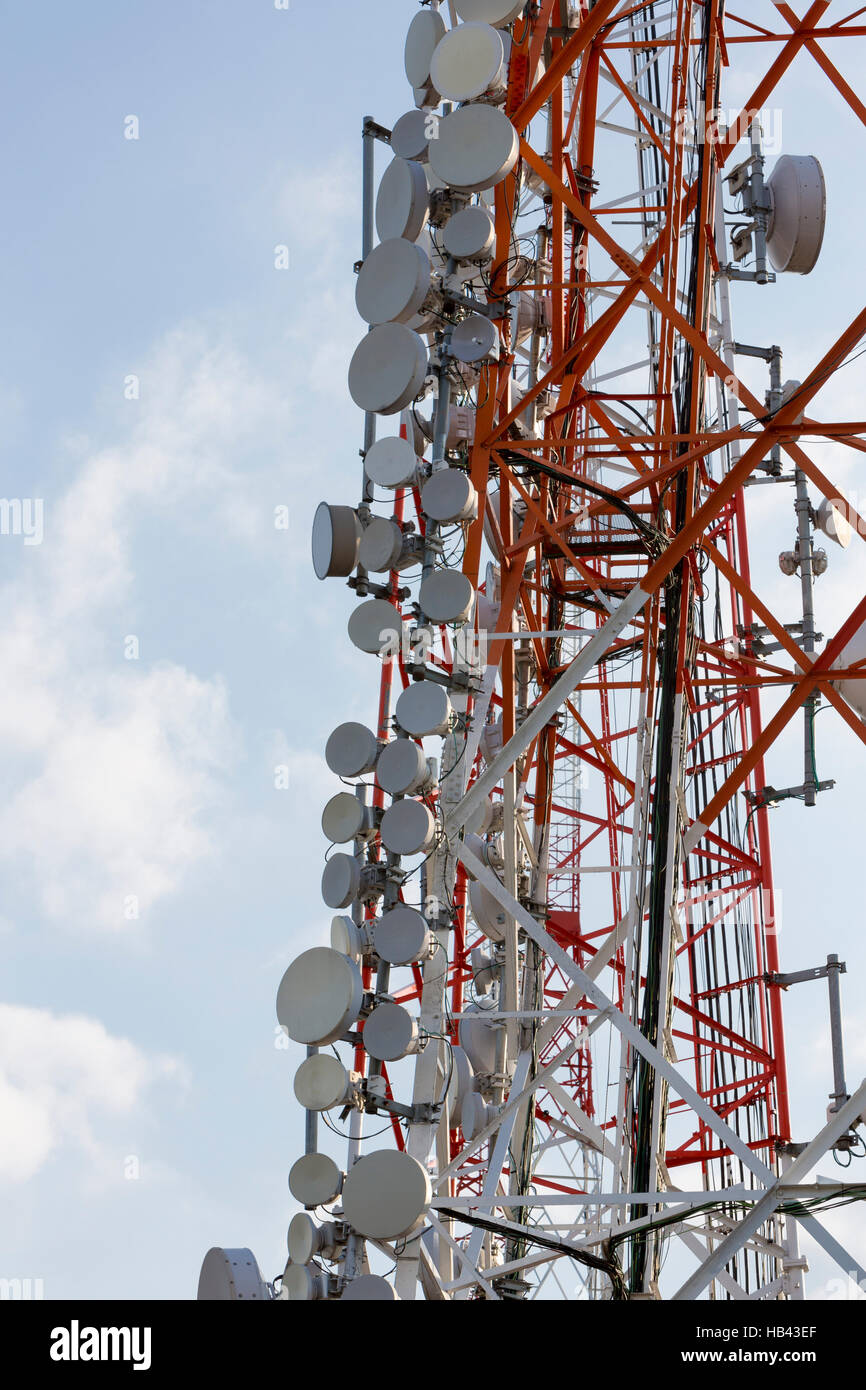 Communication tower and satellite dishes on blue sky background Stock ...