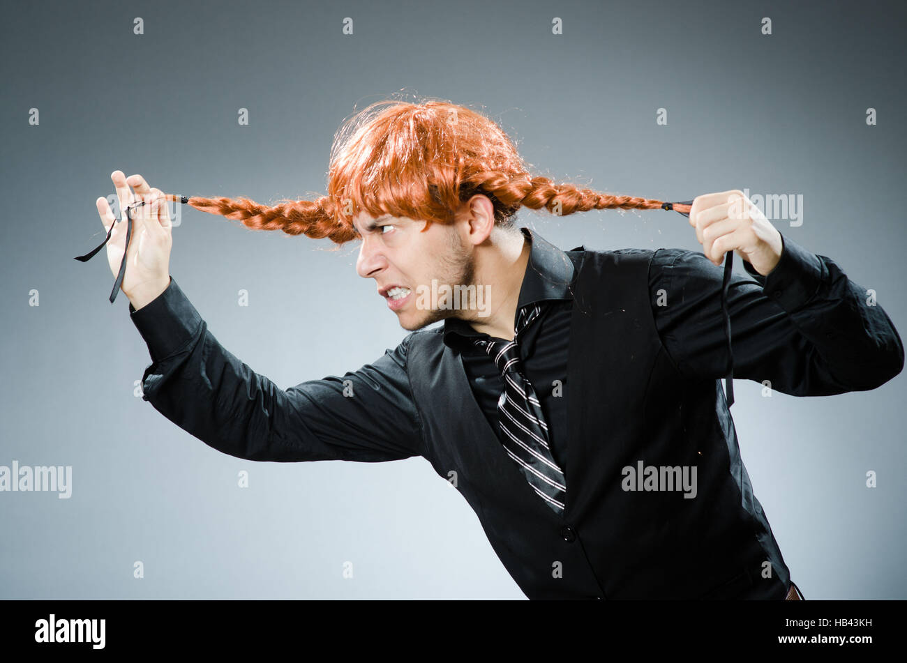 Funny man with red hair wig Stock Photo - Alamy
