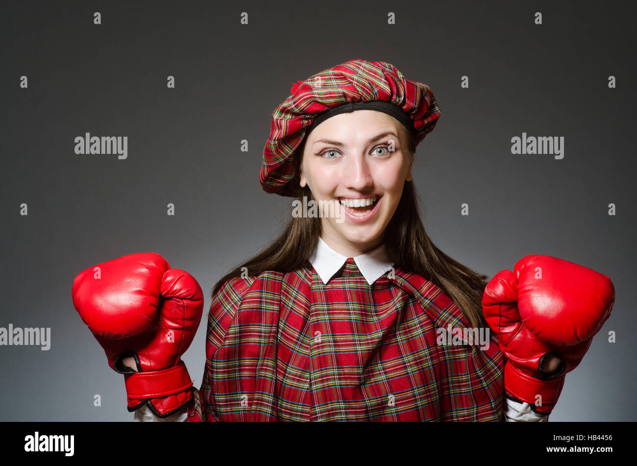 Woman in scottish clothing in boxing concept Stock Photo - Alamy