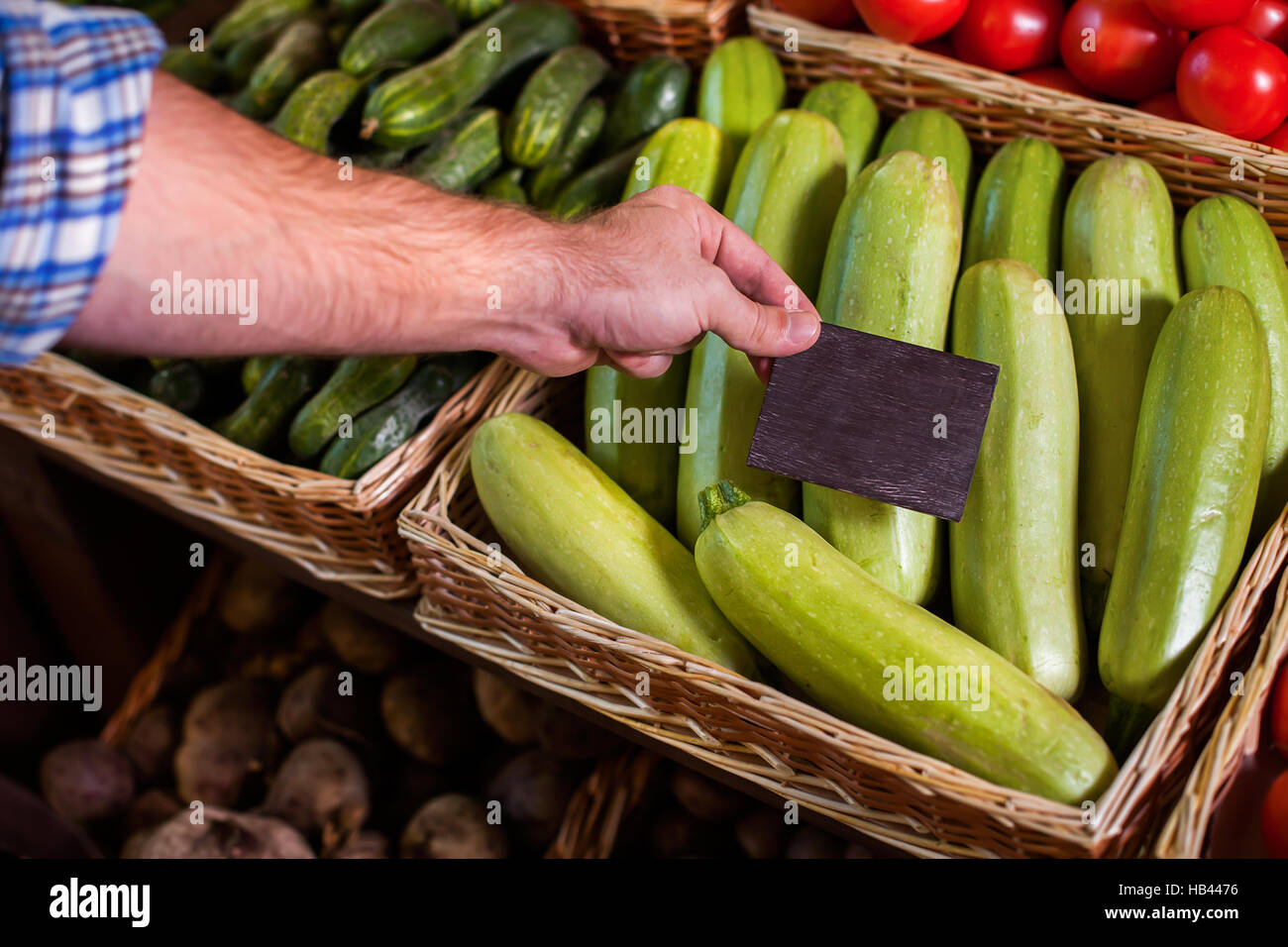 Price tag installation on vegetable marrow Stock Photo - Alamy