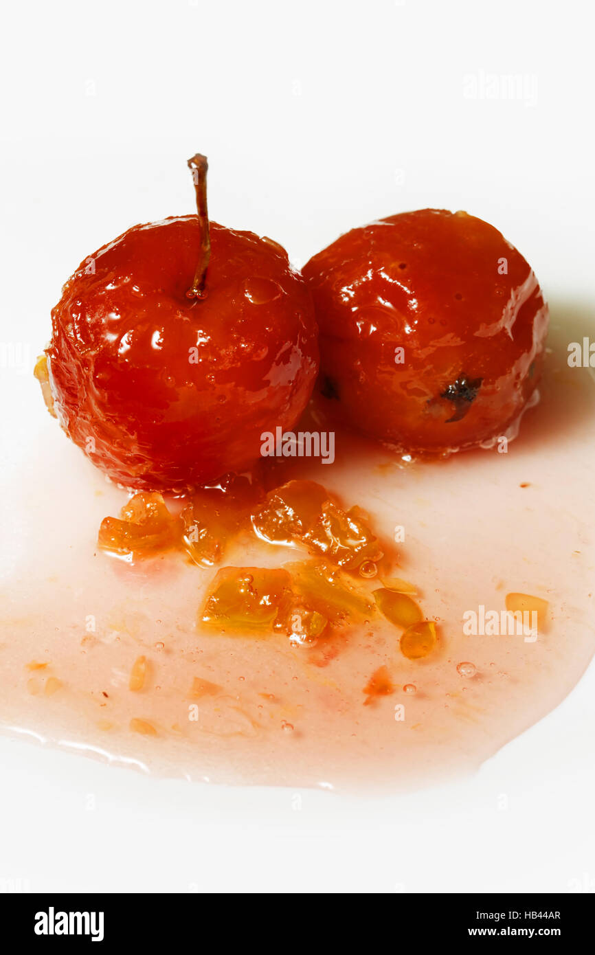 Red apples in rose syrup Stock Photo - Alamy