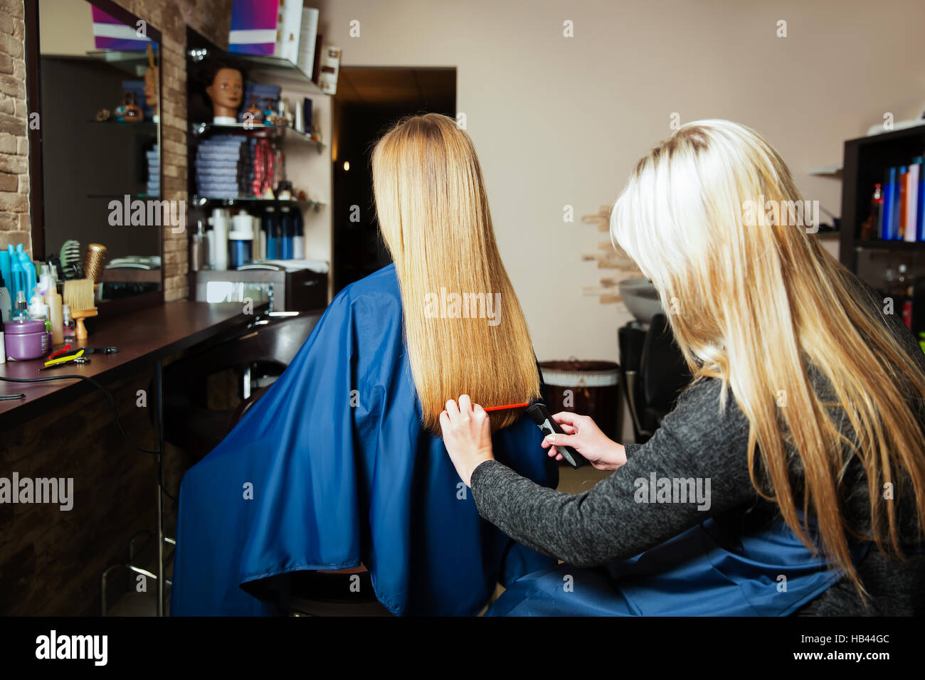 Hairdresser with machine for hair and hairbrush Stock Photo - Alamy