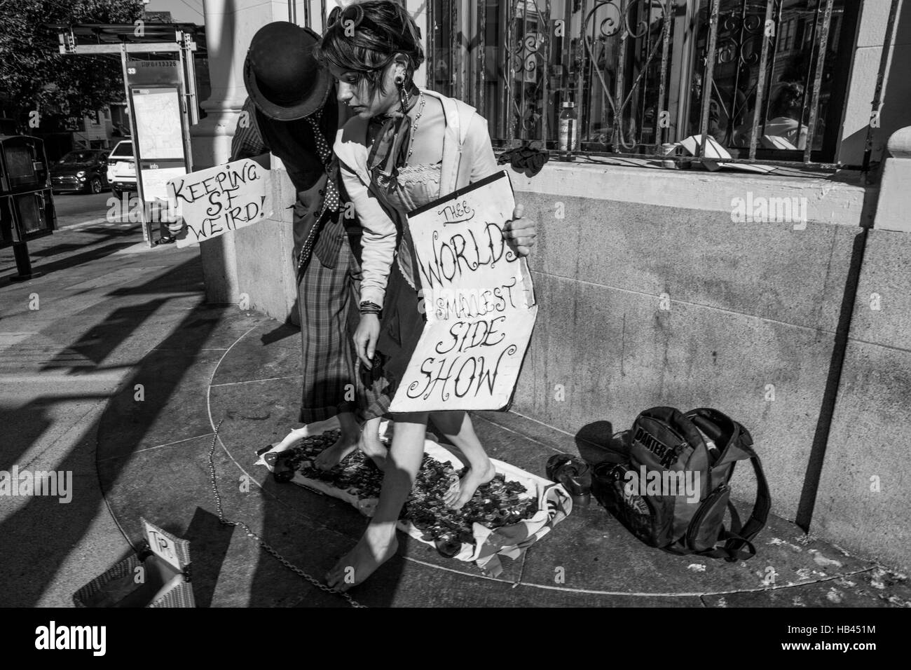 Couple performing in the street with nice message boards Stock Photo ...