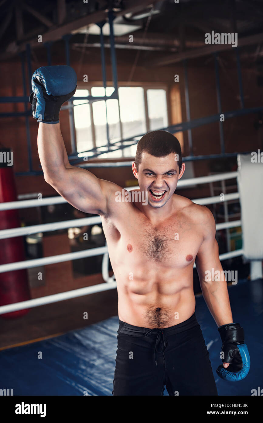 Boxer with an angry face has raised a hand up Stock Photo - Alamy