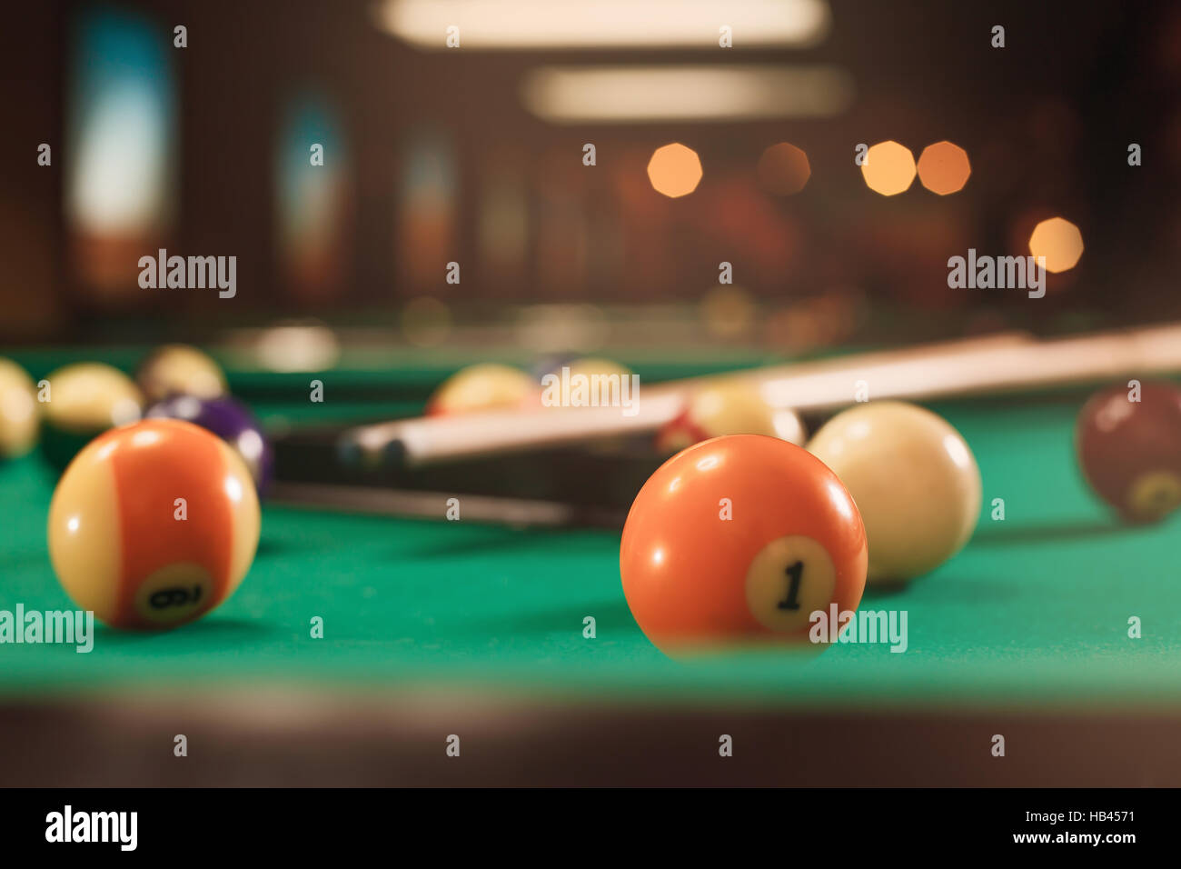Billiard balls near by cue on the pool table Stock Photo - Alamy