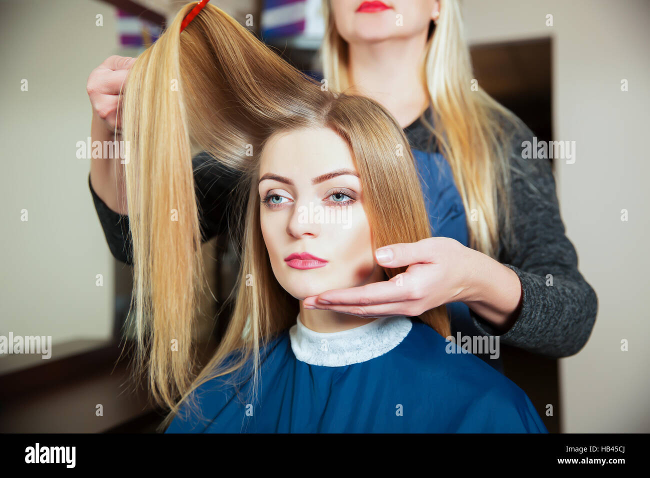 Hairdresser making hairstyle with hairbrush Stock Photo - Alamy