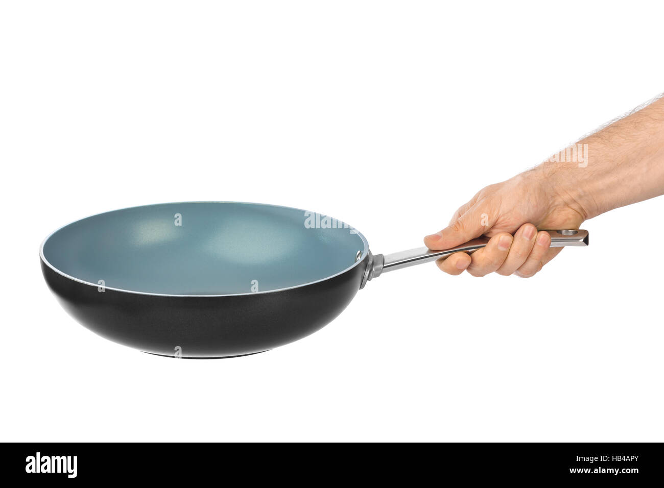Hand with frying pan Stock Photo - Alamy